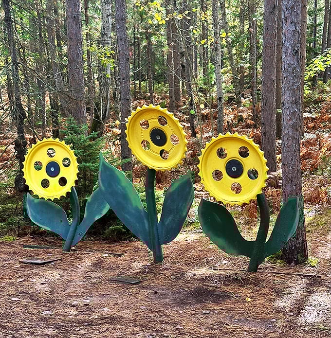 Industrial wheels transform into cheerful metal flowers, proving that with enough creativity, even the most utilitarian objects can bloom into art.