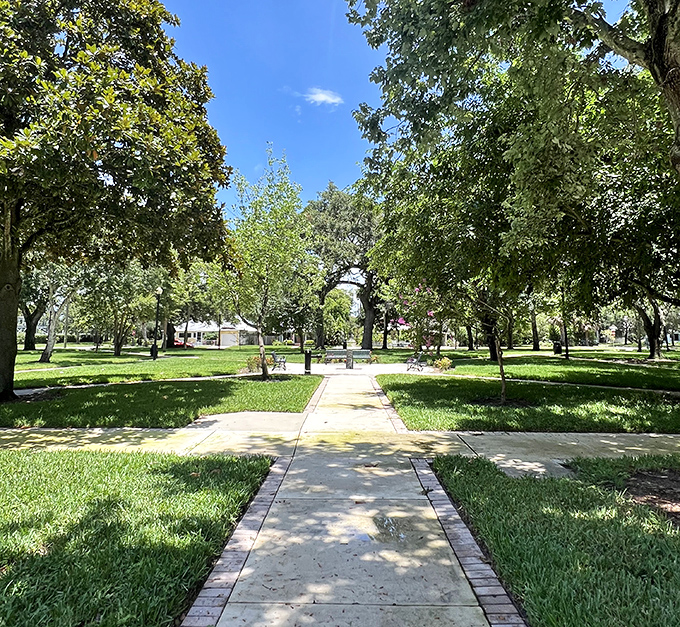 Dappled sunlight filters through ancient oaks at George Touhy Park, nature's own cathedral ceiling above Sanford's green sanctuary.