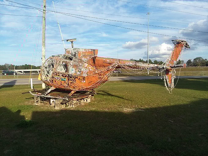 An abandoned helicopter finds unexpected retirement as art, proving that at Hong Kong Willie's, even aviation equipment deserves a second act.