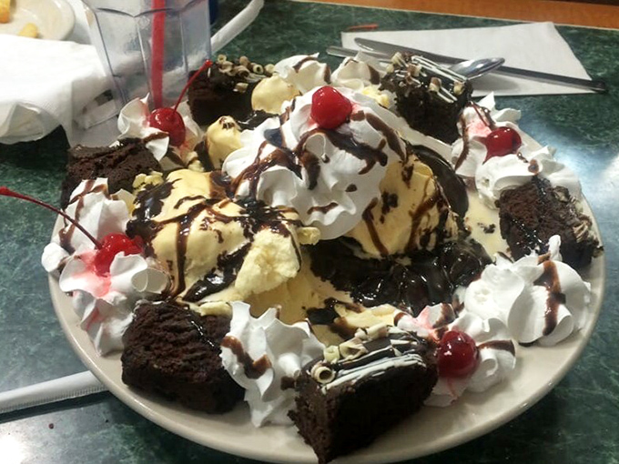 Families bond over these shared dessert experiences, creating memories sweeter than the hot fudge cascading down the sides of this cream monument.