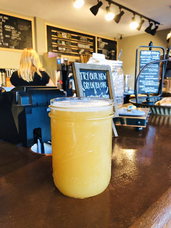 The rustic-chic ordering counter showcases a new tea chai offering, with warm wooden accents and inviting atmosphere.