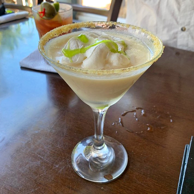 The Key Lime Martini transforms Florida's signature dessert into liquid form, complete with a graham cracker rim that'll have you wondering why all drinks don't come dessert-adjacent.