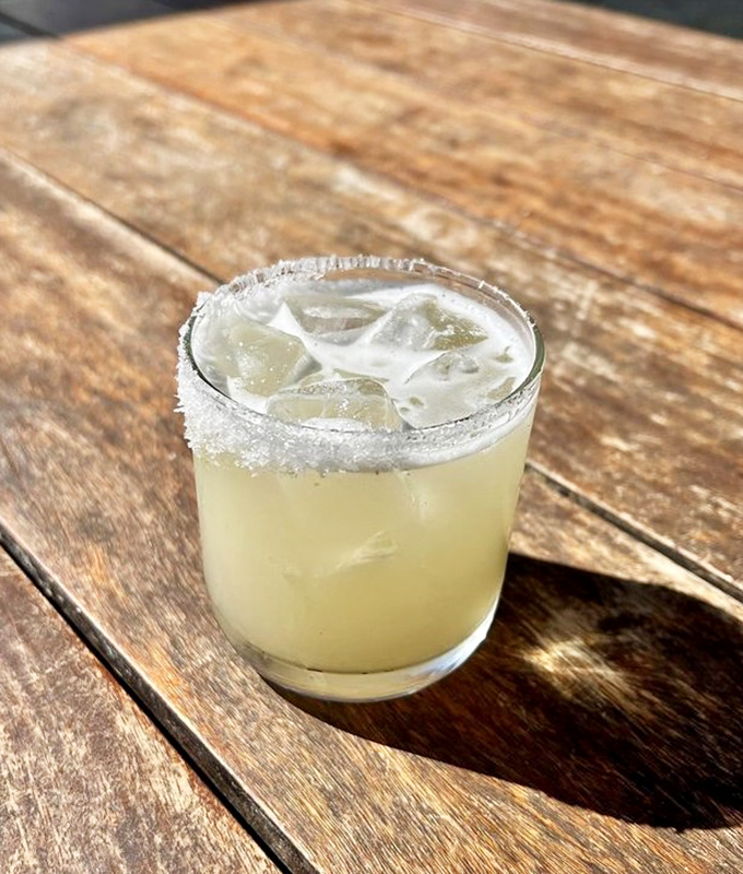 A perfectly balanced margarita with its salt-rimmed edge &ndash; like a tiny vacation in a glass, no passport required.