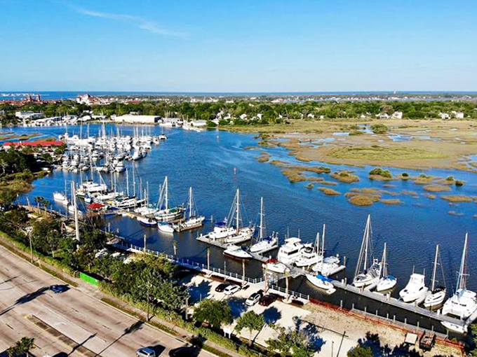 The marina's neat row of sailboats stands ready for adventure, bobbing gently in waters that have welcomed vessels from Spanish galleons to modern yachts.