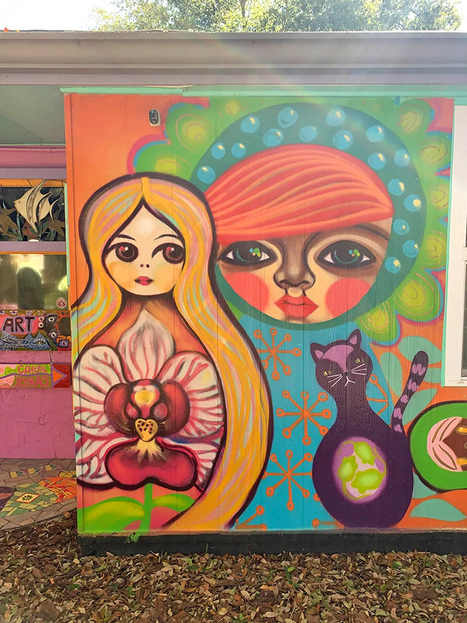 This exterior mural featuring two faces and a cosmic cat proves that conventional house paint is for people who lack imagination.