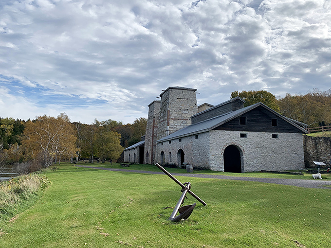 Under dramatic skies, the open grounds showcase the limestone structures that once roared with industrial might.