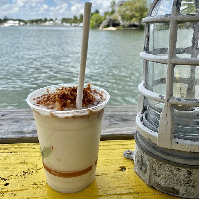 A creamy piña colada with toasted coconut garnish – because nothing says "Florida waterfront dining" quite like tropical drinks with a view.