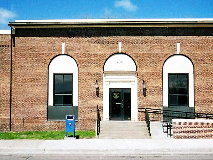 Hancock's historic post office maintains its dignified brick presence, arched windows framing a piece of American history.