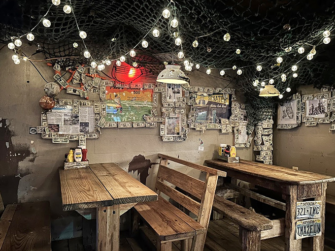 The indoor seating area feels like dining in a fisherman's scrapbook, where license plates and fishing nets create a collage of coastal memories.