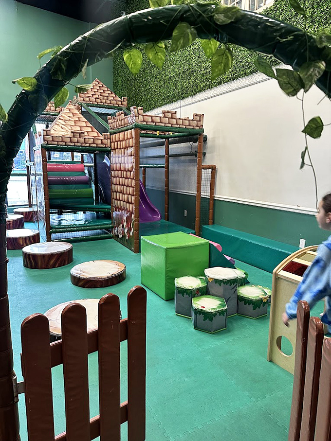 The soft play zone features adorable tree stump seating and forest-themed obstacles perfect for toddlers taking their first steps into adventure.