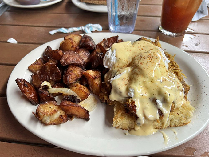Southern hospitality meets brunch royalty &ndash; a biscuit throne supporting poached eggs crowned with hollandaise and surrounded by crispy potatoes.