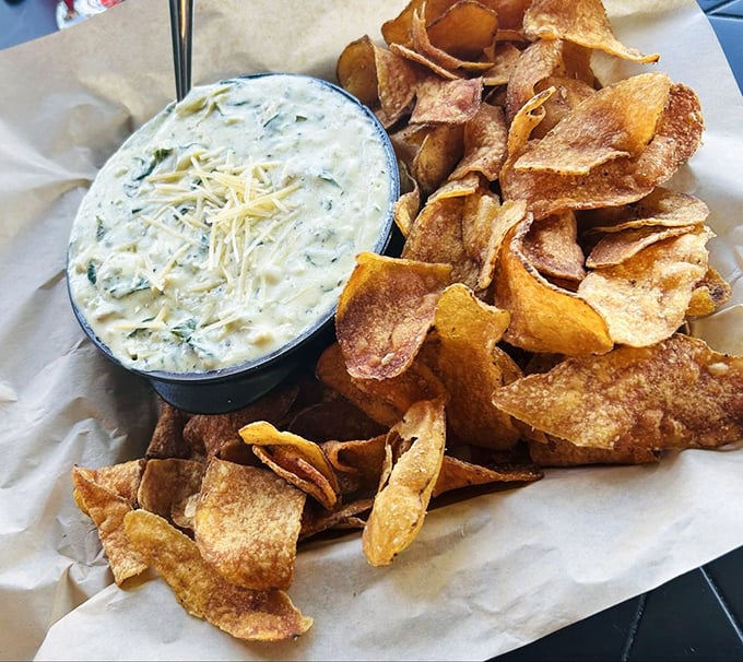 This spinach dip could start a religion &ndash; creamy, cheesy goodness paired with house-made chips sturdy enough for serious dipping action.