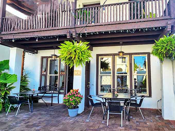 The Drunken Horse's charming patio invites visitors to linger over wine and conversation as hanging ferns sway in the Florida breeze.