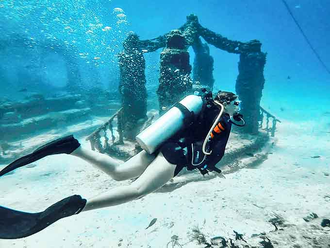 Ornate gates welcome visitors to this underwater metropolis, where human creativity and nature's persistence create something truly magical.