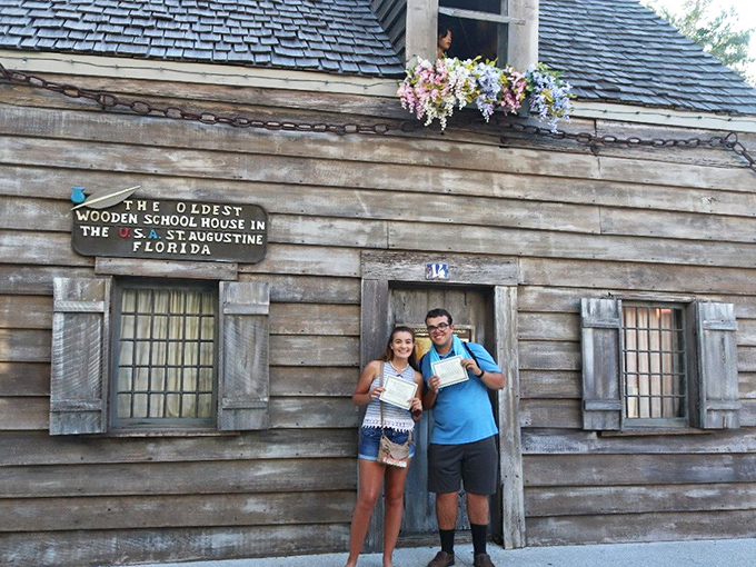 Proud graduates display their "diplomas" outside the historic schoolhouse, joining generations of visitors who've stepped back into educational history.