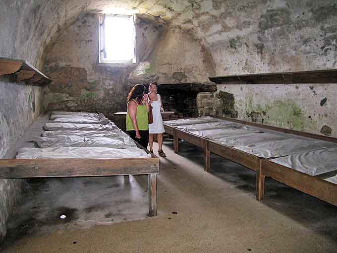 Visitors examine the austere living conditions of colonial soldiers. No Netflix, no air conditioning, no complaints allowed.