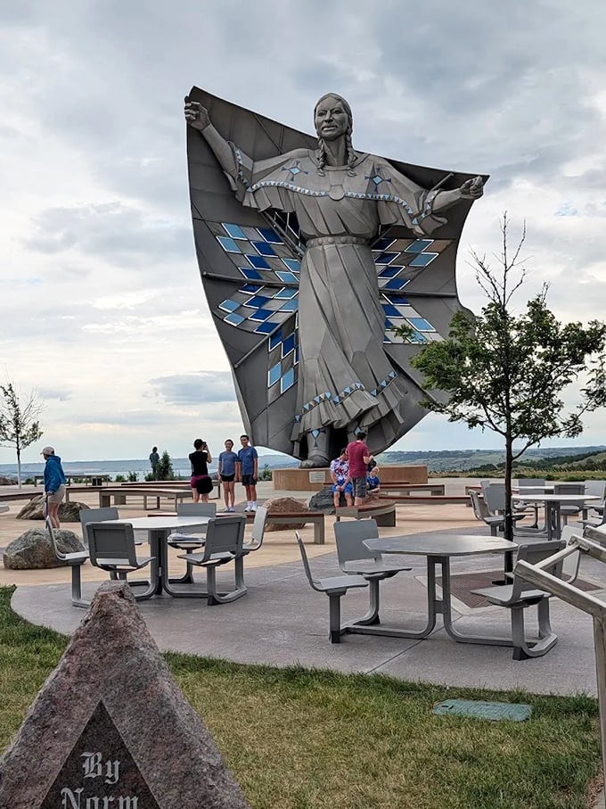 Modern visitors gather at the statue's base, their upturned faces showing the same wonder experienced by generations of travelers since the 1960s.