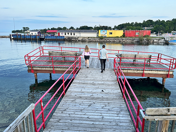 Two figures stroll toward the water's edge, participating in the time-honored tradition of "let's see what's at the end of this dock."