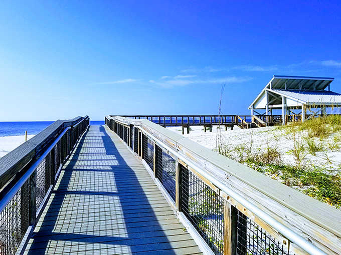 The boardwalk stretches toward endless horizons, inviting visitors to leave footprints in the sand and worries on the mainland.