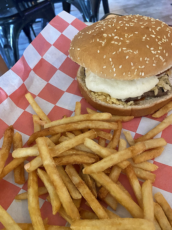 The Colombian burger doesn't whisper, it announces itself with authority&mdash;sesame-topped bun, melty cheese, and crispy fries standing at attention.