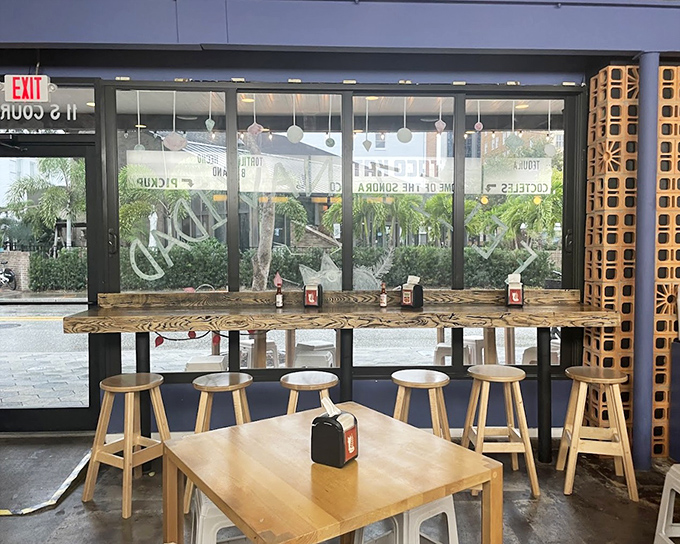 The window counter offers front-row seats to Miami's urban theater &ndash; watch the city pulse by while savoring handcrafted tacos in blissful contrast.
