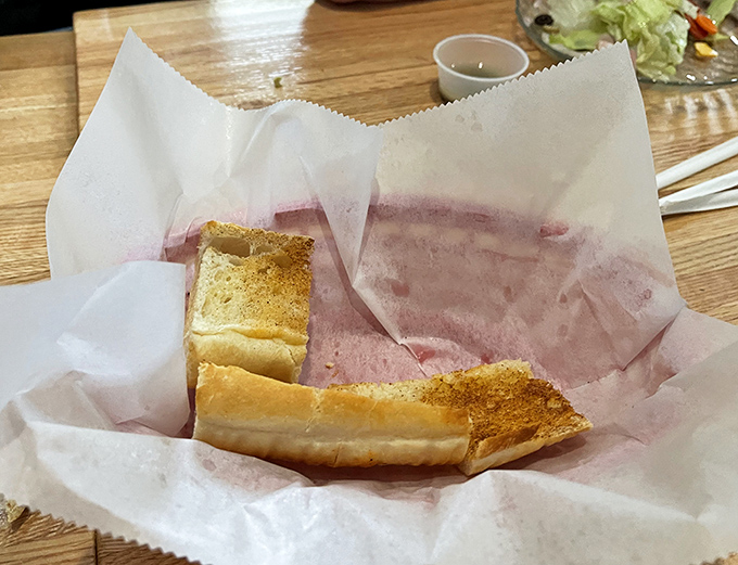 Garlic Bread: Crisp, buttery edges giving way to soft, aromatic centers &ndash; these golden slices aren't just sides, they're sauce-sopping vehicles of pure joy.