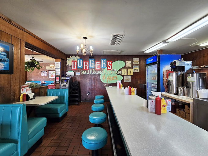 The counter seating&mdash;where solo diners become regulars and the staff eventually knows your order before you sit down. That "Burgers Milkshakes Fries" sign tells you everything you need to know.