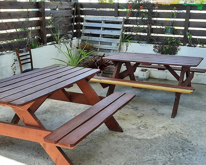 Simple wooden picnic tables create an unpretentious oasis where the only thing that matters is the food and the company you're sharing it with.