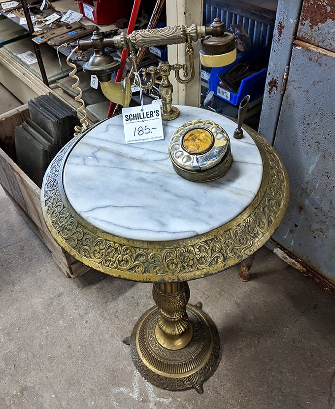 This marble-topped telephone table with ornate brass details isn't just furniture &ndash; it's a time machine to an era of rotary dials.