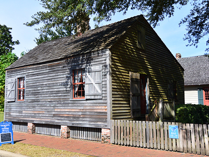 Julee Cottage's simple wooden frame holds powerful history, its modest "shotgun" design a rare survivor of early Pensacola architecture.