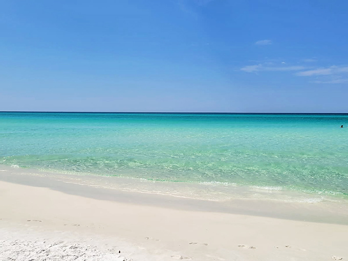 Topsail Hill's massive white dunes roll like a desert landscape, just steps away from emerald Gulf waters and rare coastal dune lakes.