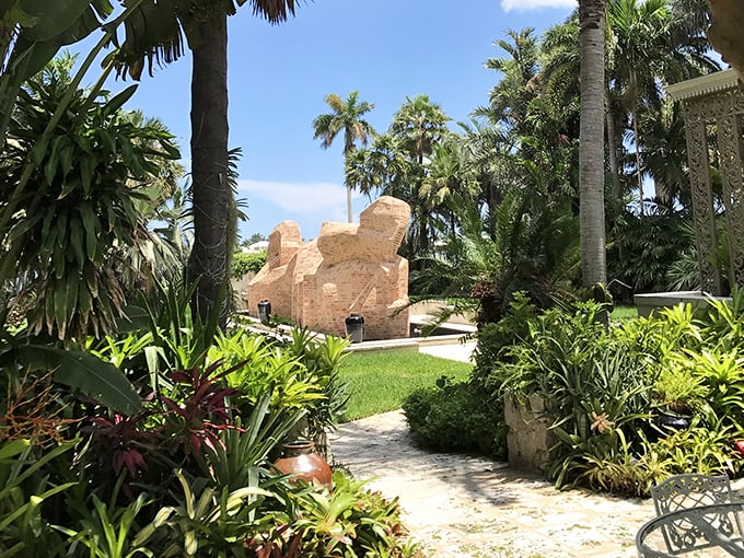 These brick giants seem to grow from the ground itself, their warm tones complementing the lush tropical setting of Ann Norton's artistic vision.