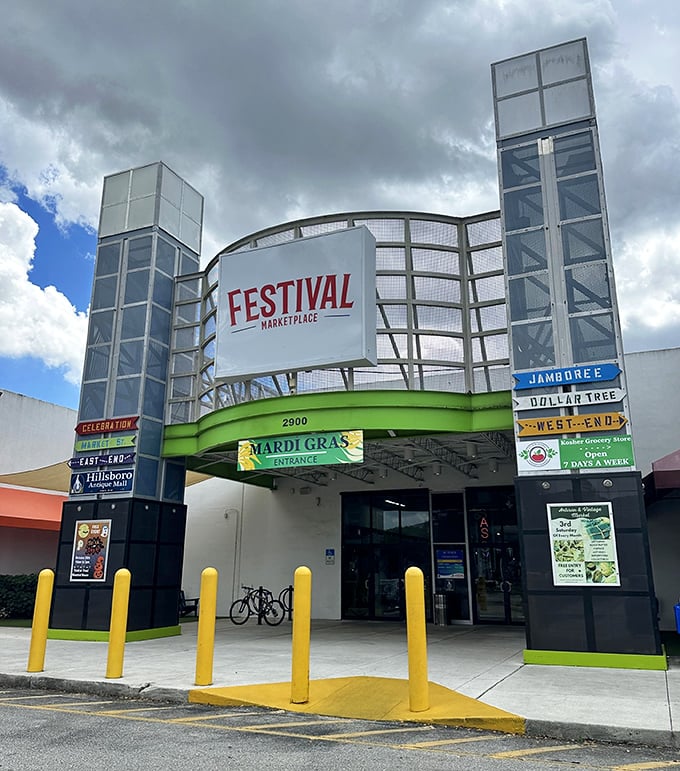 Storm clouds frame retail therapy! Festival's impressive entrance promises indoor adventures while Mardi Gras banners add a touch of celebration to this bargain paradise.