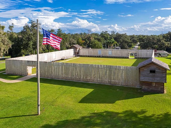 The reconstructed wooden fort stands as a testament to pioneer resilience, its tall walls and simple construction reflecting early American military design.