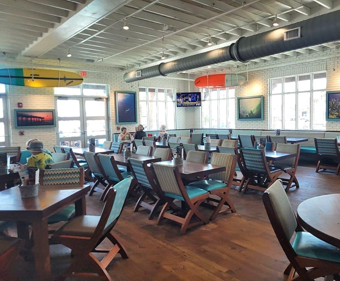 The airy interior of Salt Life Food Shack features comfortable seating, wooden tables, and a casual coastal vibe that makes everyone feel welcome. Beach vibes without the sand!