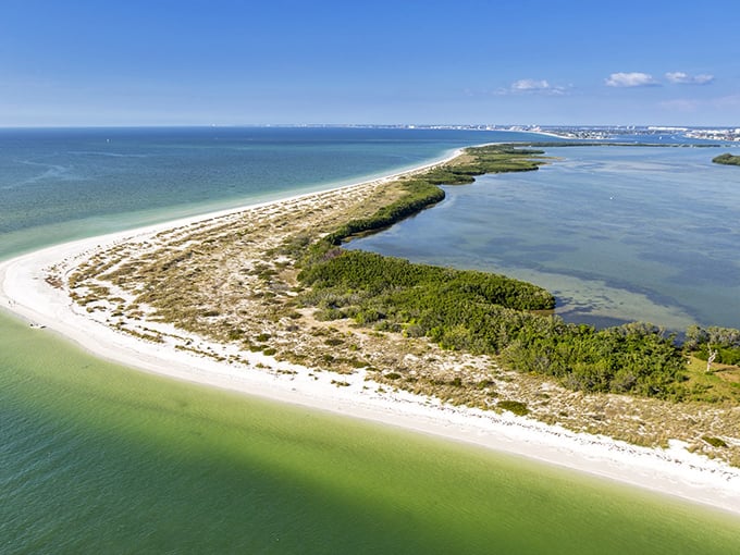 The barrier island stretches like a protective embrace around its lagoon &ndash; nature's own gated community.