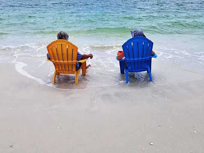 Beach Chair Philosophy: Two colorful thrones for temporary royalty, where the only agenda is watching waves perform their endless dance.