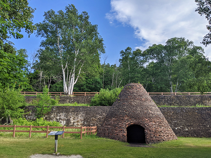 The charcoal kiln resembles a stone beehive where workers once transformed forests into fuel—nature's recipe for industrial progress.