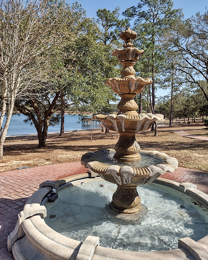 Circle Drive's ornate fountain creates a soothing soundtrack for lakeside contemplation, its waters dancing upward before rejoining the perfect circle below.