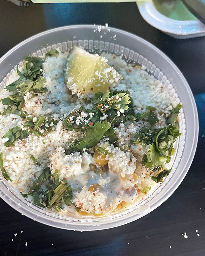 Corn esquites &ndash; summer in a cup. The queso fresco melts slightly into the warm kernels, creating a creamy-sweet-tangy symphony that's utterly addictive.