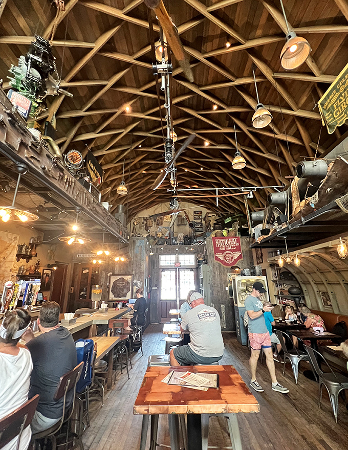 Fellow adventurers gather at wooden tables, sharing tales of their day's exploits under the watchful gaze of vintage memorabilia.
