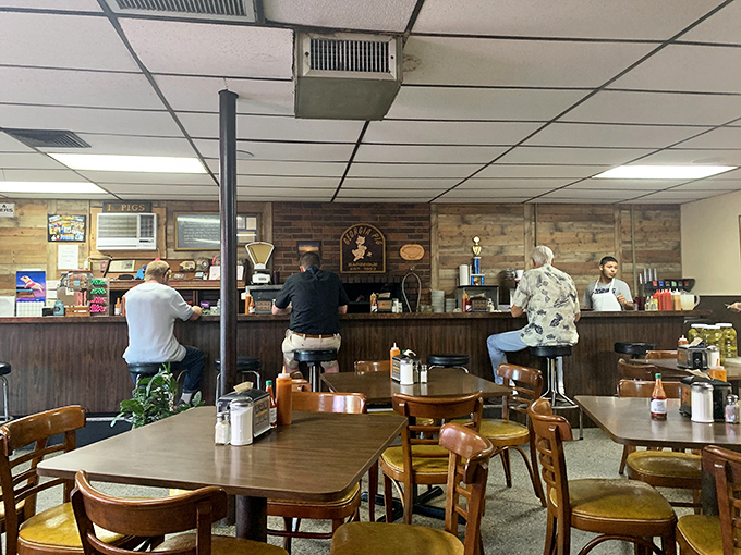 The dining area where countless conversations and meals have been shared &ndash; notice the wood-paneled walls that have absorbed decades of barbecue smoke.