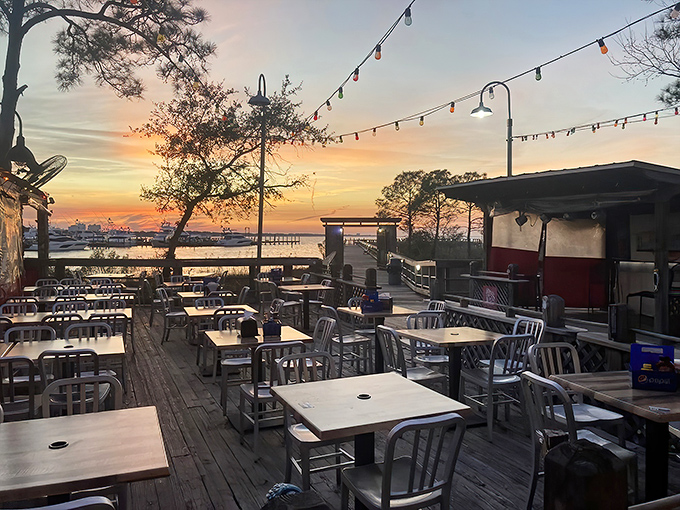 Sunset dining with string lights and empty tables calling your name. The kind of patio that makes you want to order "one of everything."
