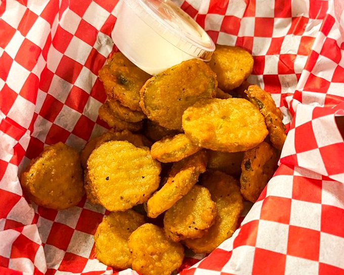 These aren't just fried pickle chips&mdash;they're tangy little discs of happiness, golden-fried to perfection and served with a creamy dipping sauce.