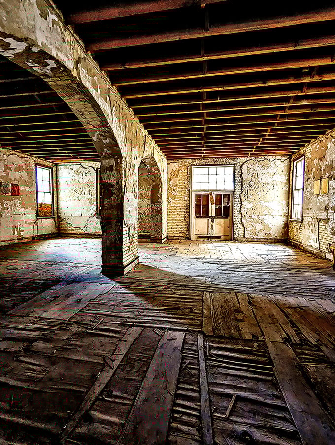 Exposed wooden beams and weathered brick walls reveal the bones of this historic structure, waiting patiently for restoration to breathe new life into forgotten spaces.