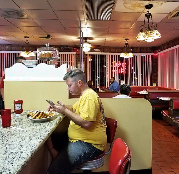 The counter seating offers front-row tickets to the breakfast show, where coffee flows freely and conversation is always on the menu.