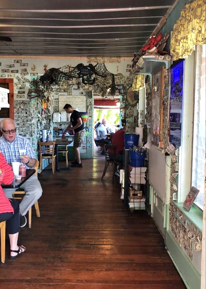 Dollar bills papering the walls tell stories of visitors past, while fishing nets overhead remind you where your lunch recently resided.
