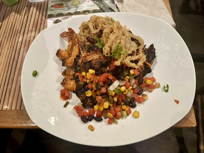 This tropical plate combines grilled chicken and succulent shrimp with colorful vegetables &ndash; vacation vibes served with a side of culinary wanderlust.