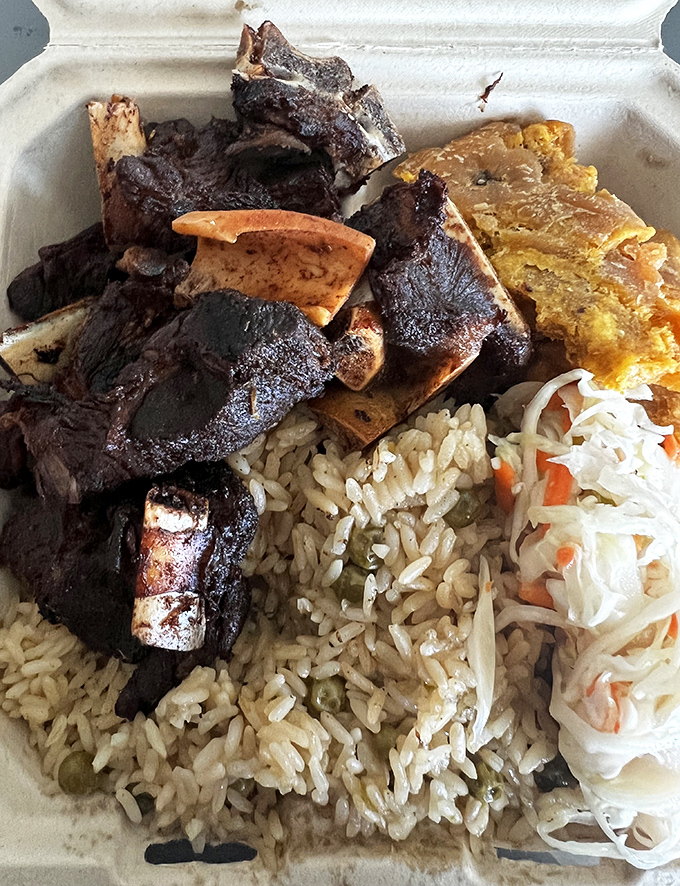 Charred edges give way to succulent meat that's been slow-dancing with scotch bonnet peppers and allspice for hours.