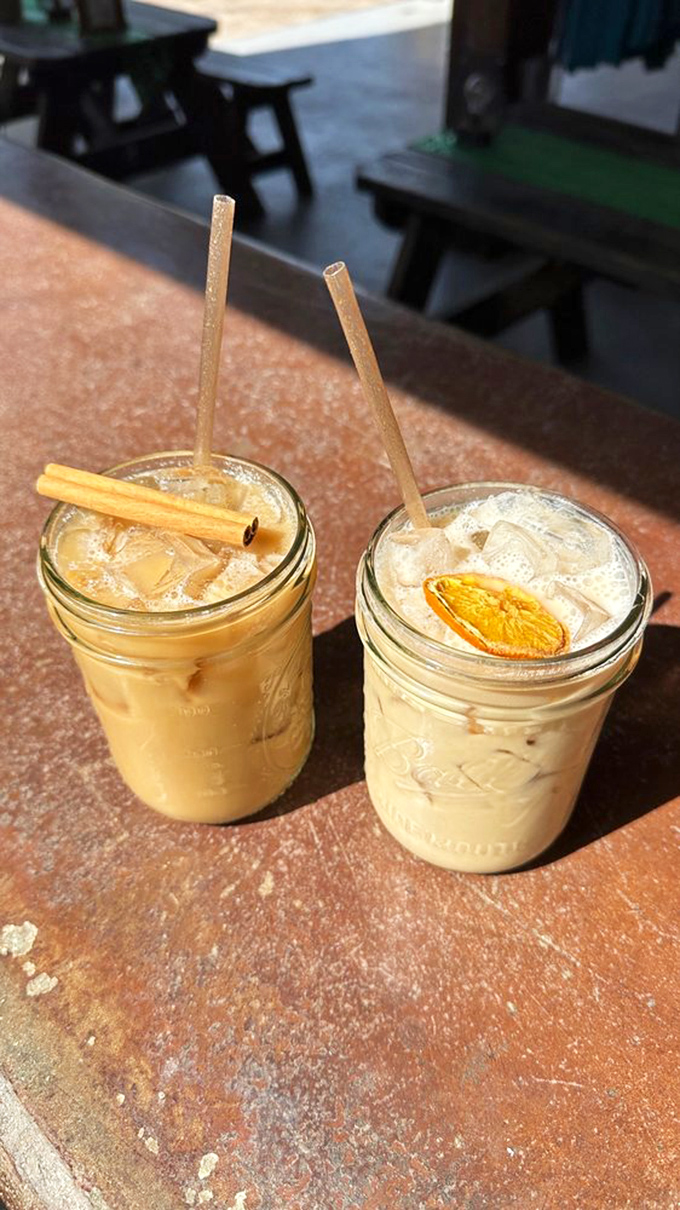 Two tempting mason jars of creamy goodness &ndash; one cinnamon-topped chai latte and one citrus-garnished specialty &ndash; await lucky patrons.
